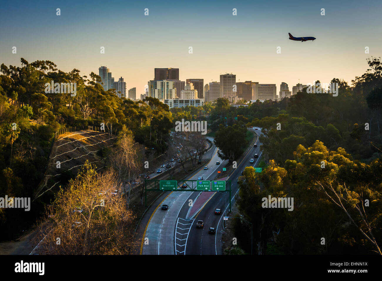 Landing airplane over California Route 163 and the San Diego Skyline ...