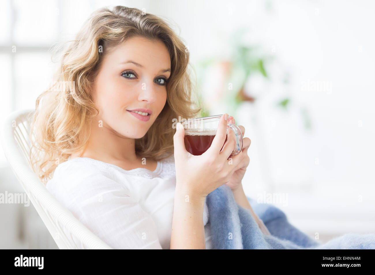 Woman drinking hot beverage Stock Photo - Alamy