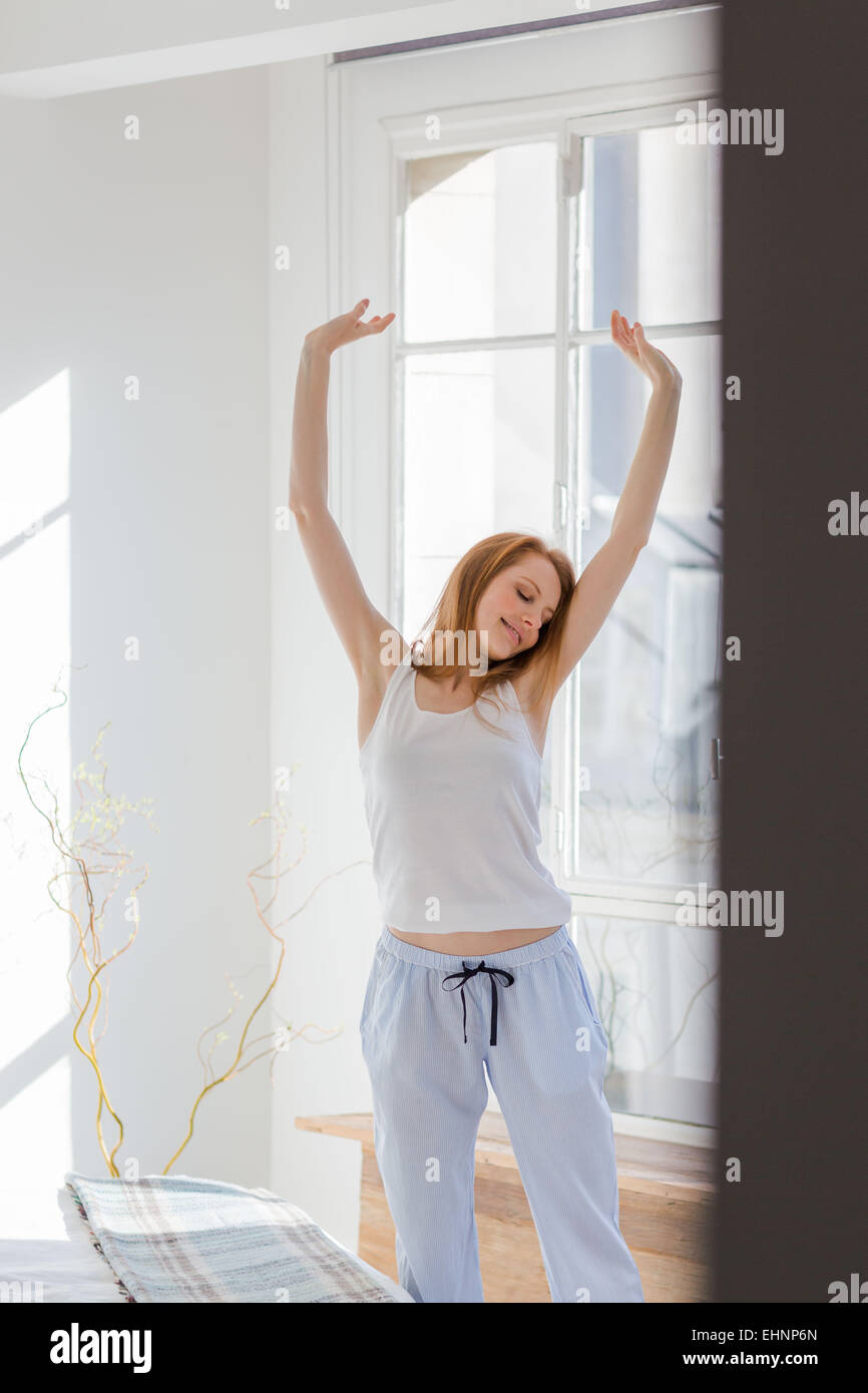 Woman waking up and stretching Stock Photo - Alamy