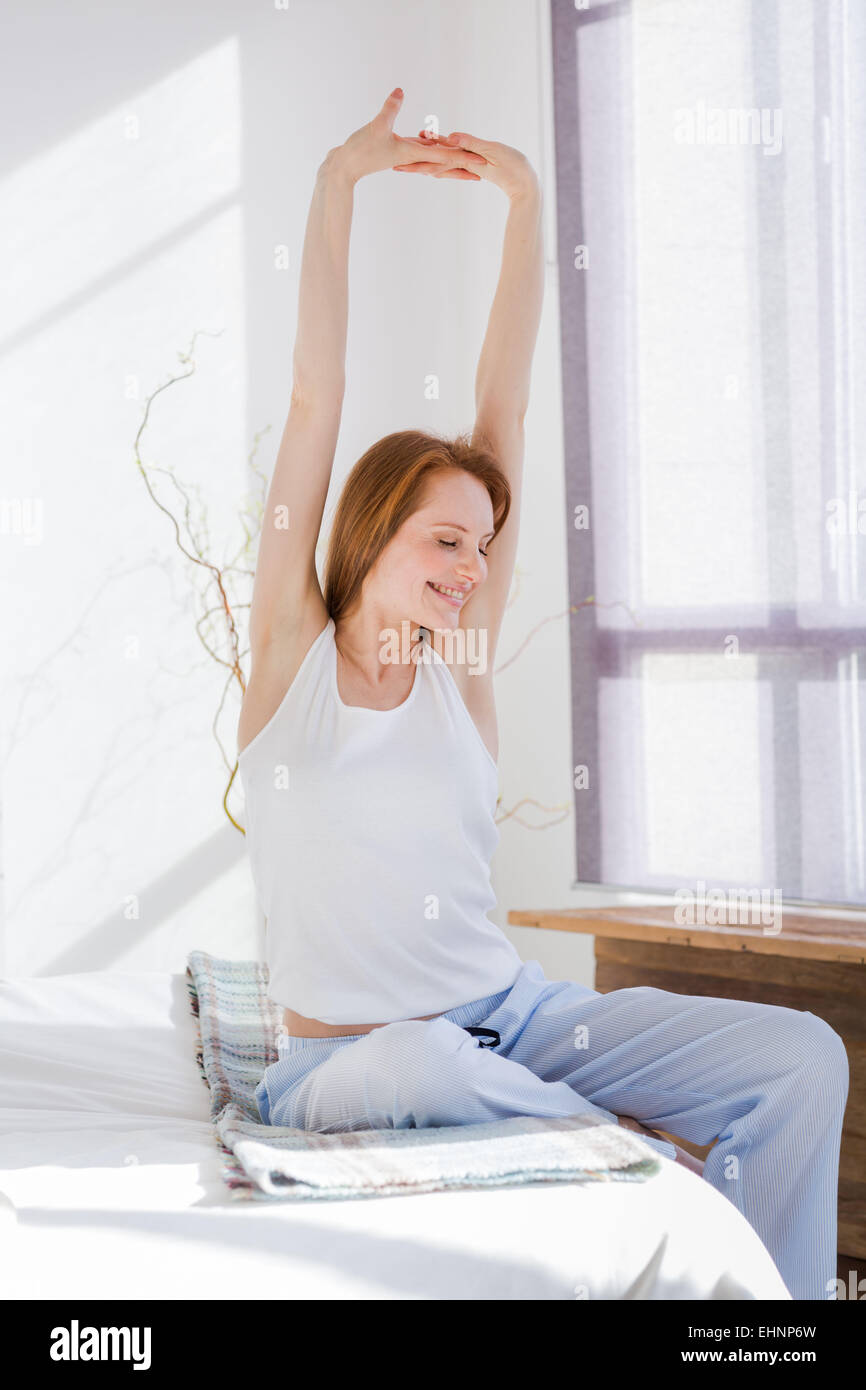 Woman waking up and stretching Stock Photo - Alamy