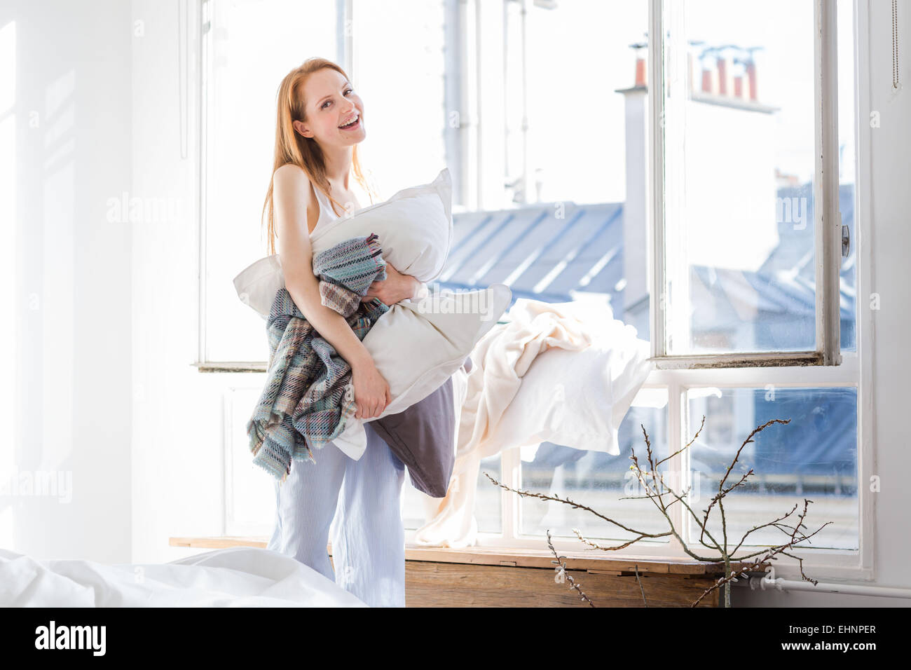 Woman making the bed Stock Photo - Alamy