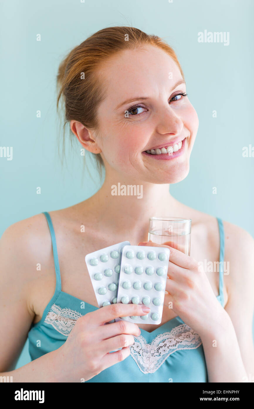 Woman taking medicines Stock Photo - Alamy