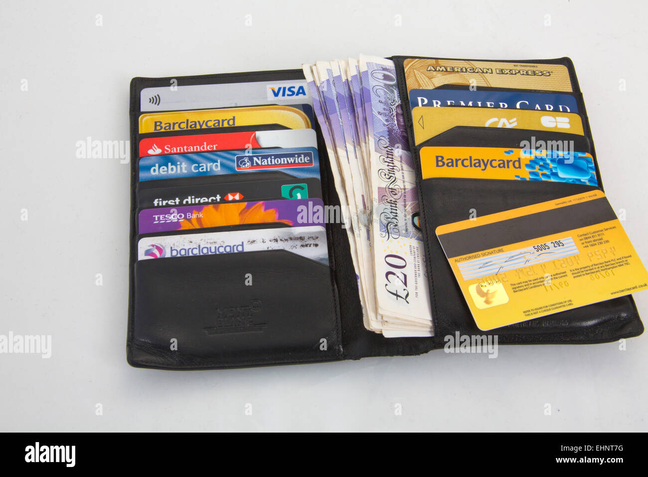 Black wallet with Assortment of credit cards Visa and American express ...