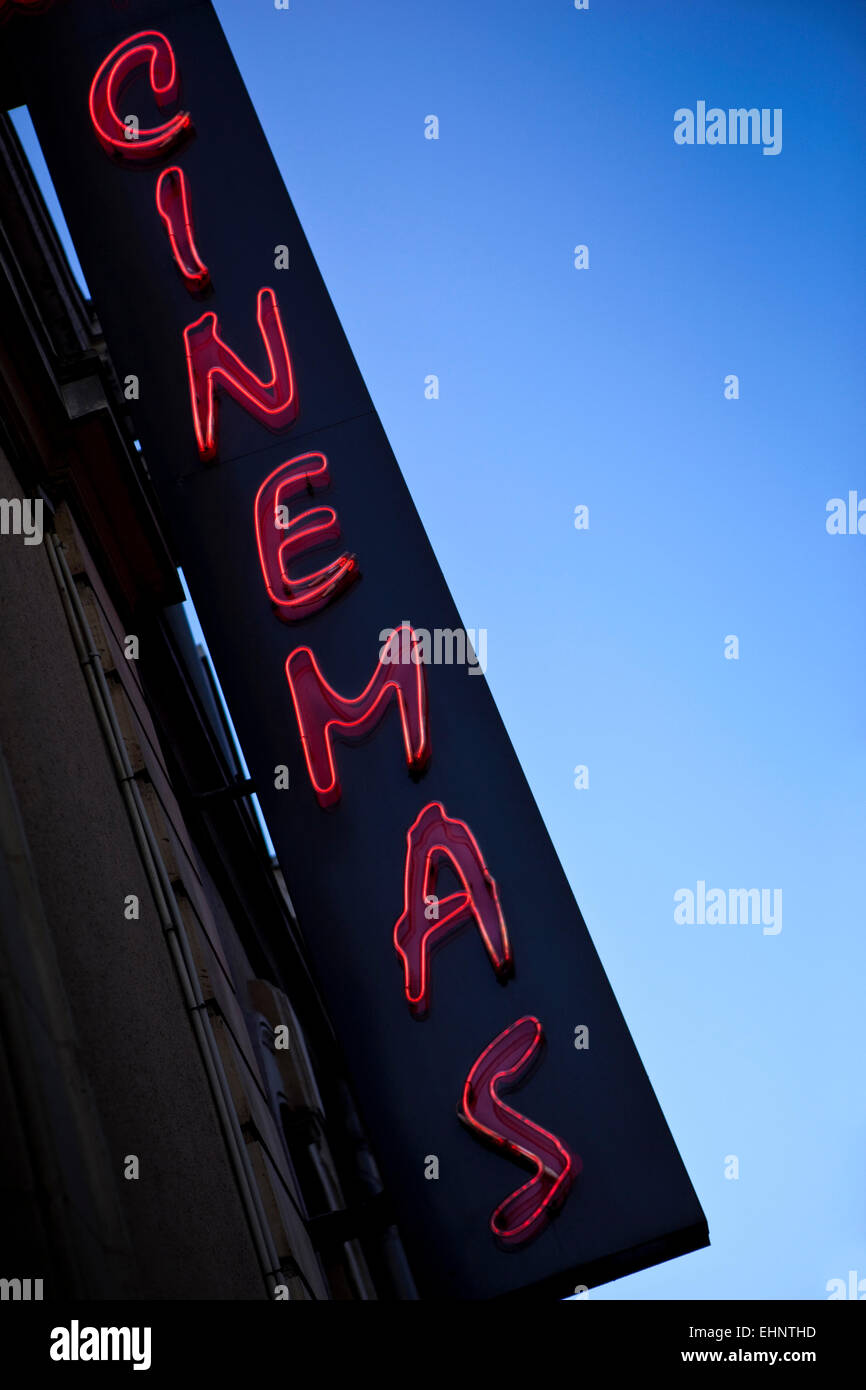 Neon sign of a movie theater in town Stock Photo - Alamy