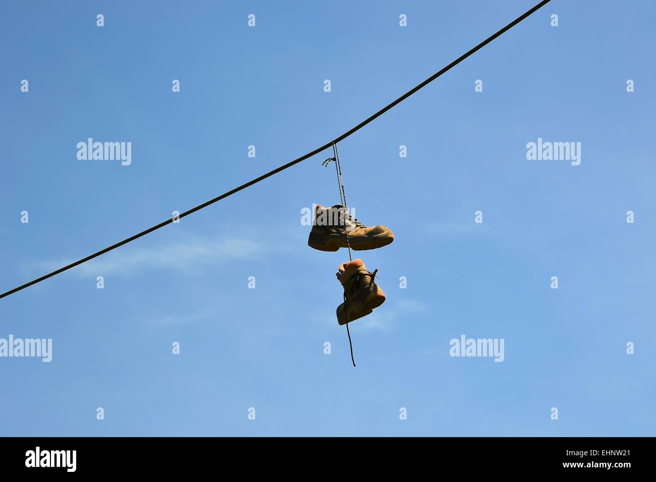 shoes hanging on a power line Stock Photo - Alamy
