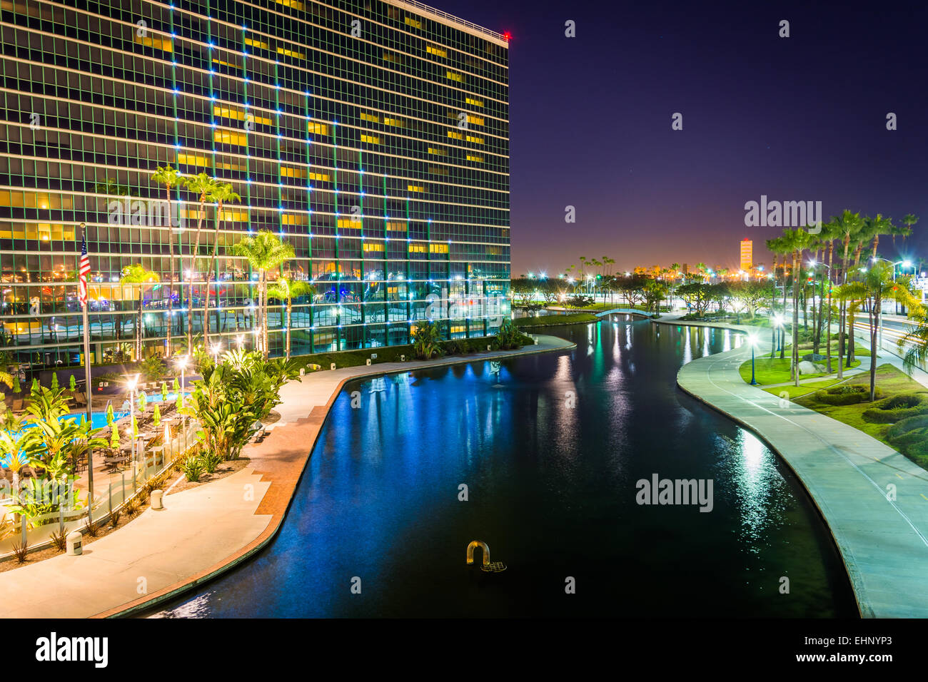 View of a modern building and Rainbow Lagoon Park at night, in Long ...