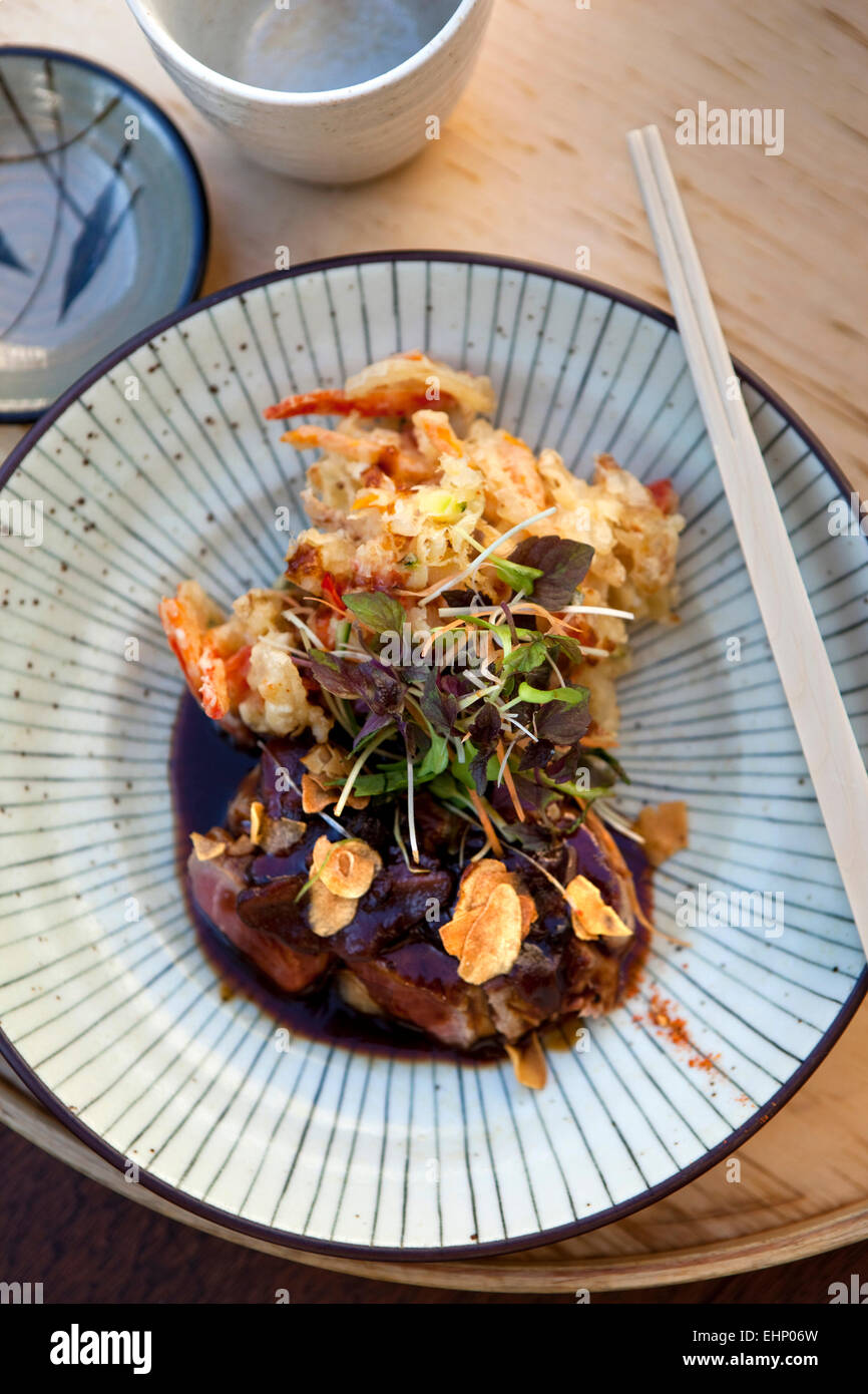 Japanese dish with vegetable tempura, beef, soy sauce and salad Stock ...