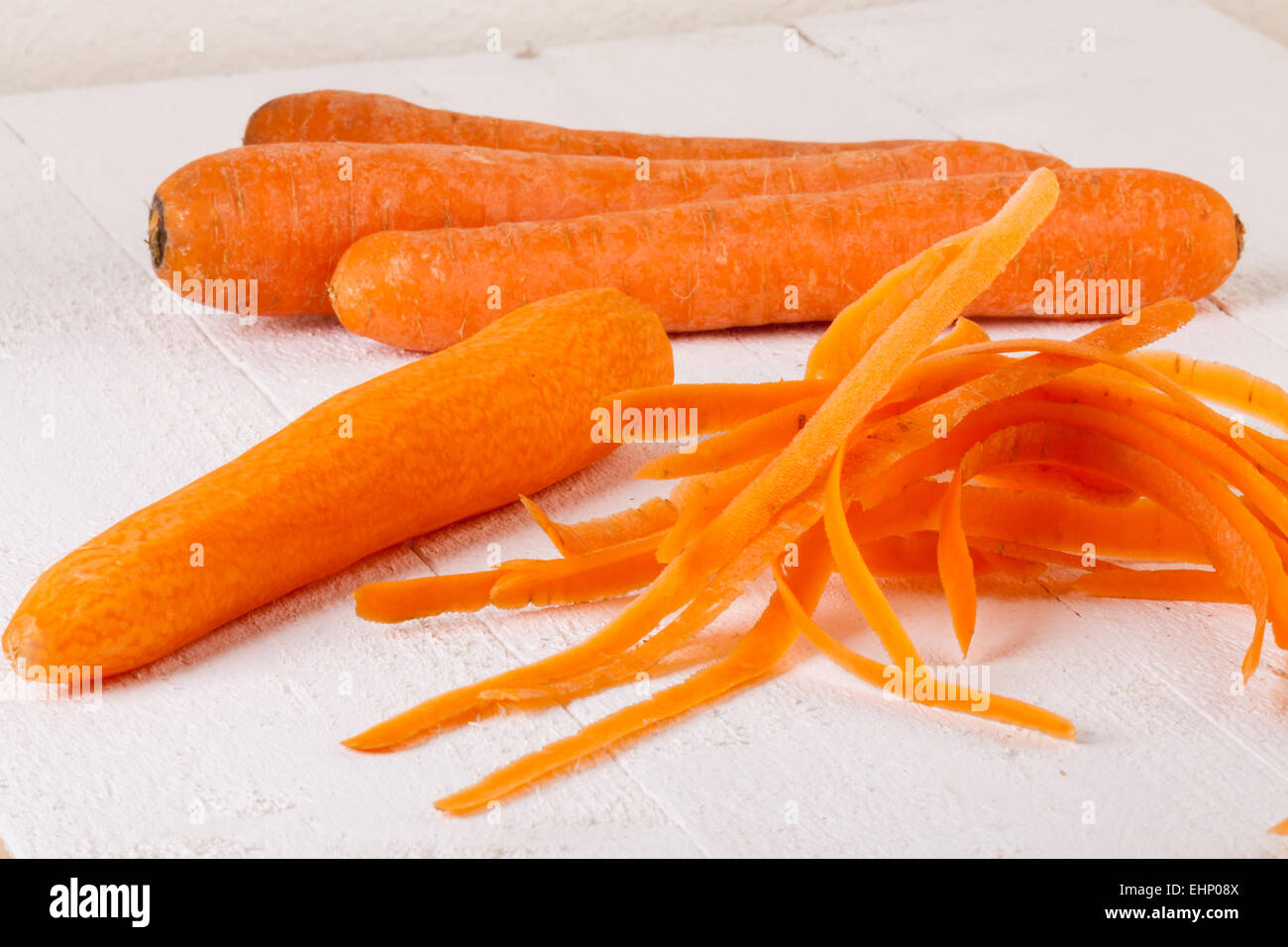 Fresh peeled carrots sliced into thin batons for carrot julienne with a ...