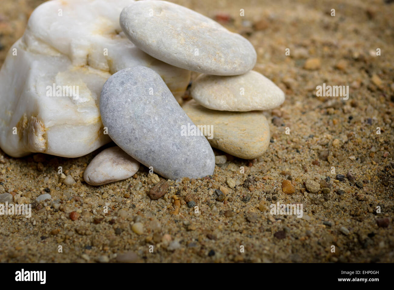 Stones stacked in sand background Stock Photo - Alamy