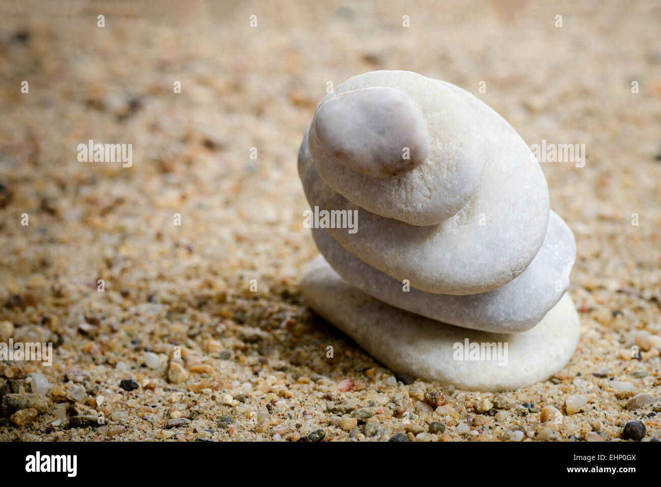 Stones stacked in sand background Stock Photo - Alamy