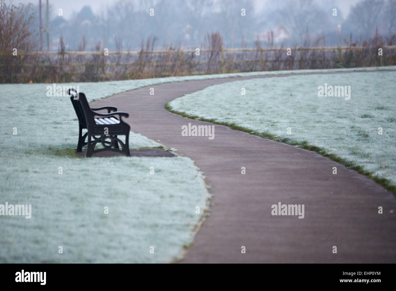 Bench and curved path surrounded by frost covered grass Stock Photo - Alamy