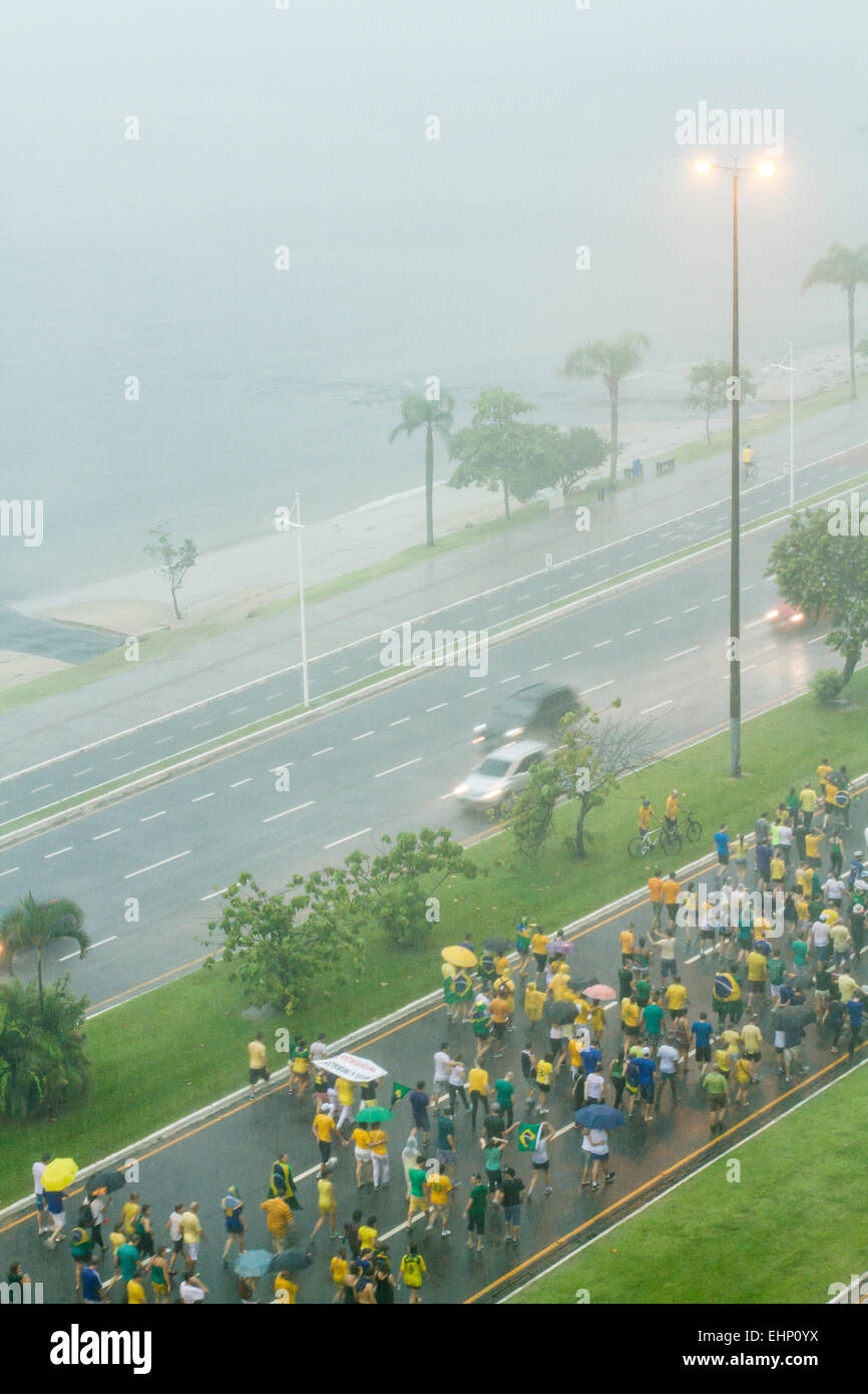 Protesters walk on Beira Mar Norte Avenue under heavy rain in the ...