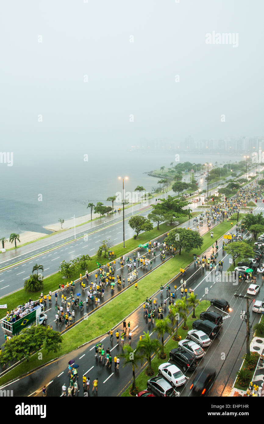 Protesters walk on Beira Mar Norte Avenue under heavy rain in the ...