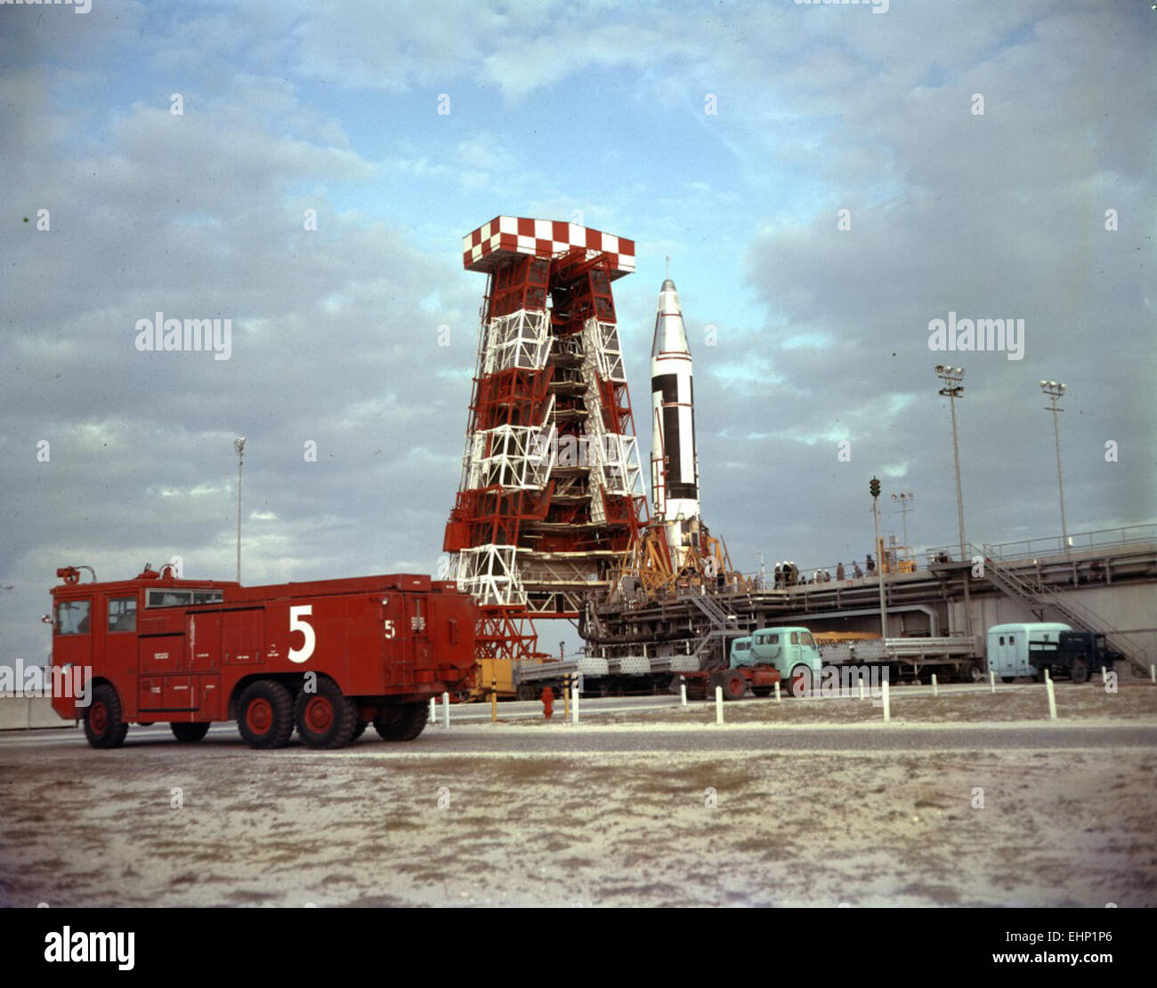 The Atlas 10A rocket on the launch pad, with a red truck positioned ...