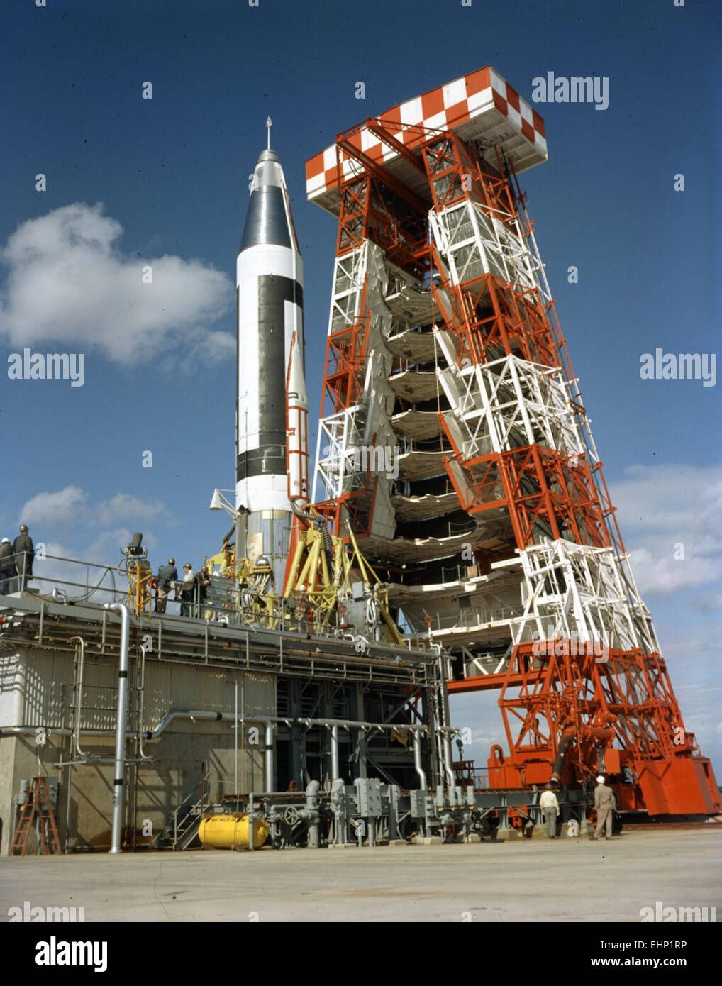 A photograph of the Atlas 12A missile on the launch pad, with the tower ...