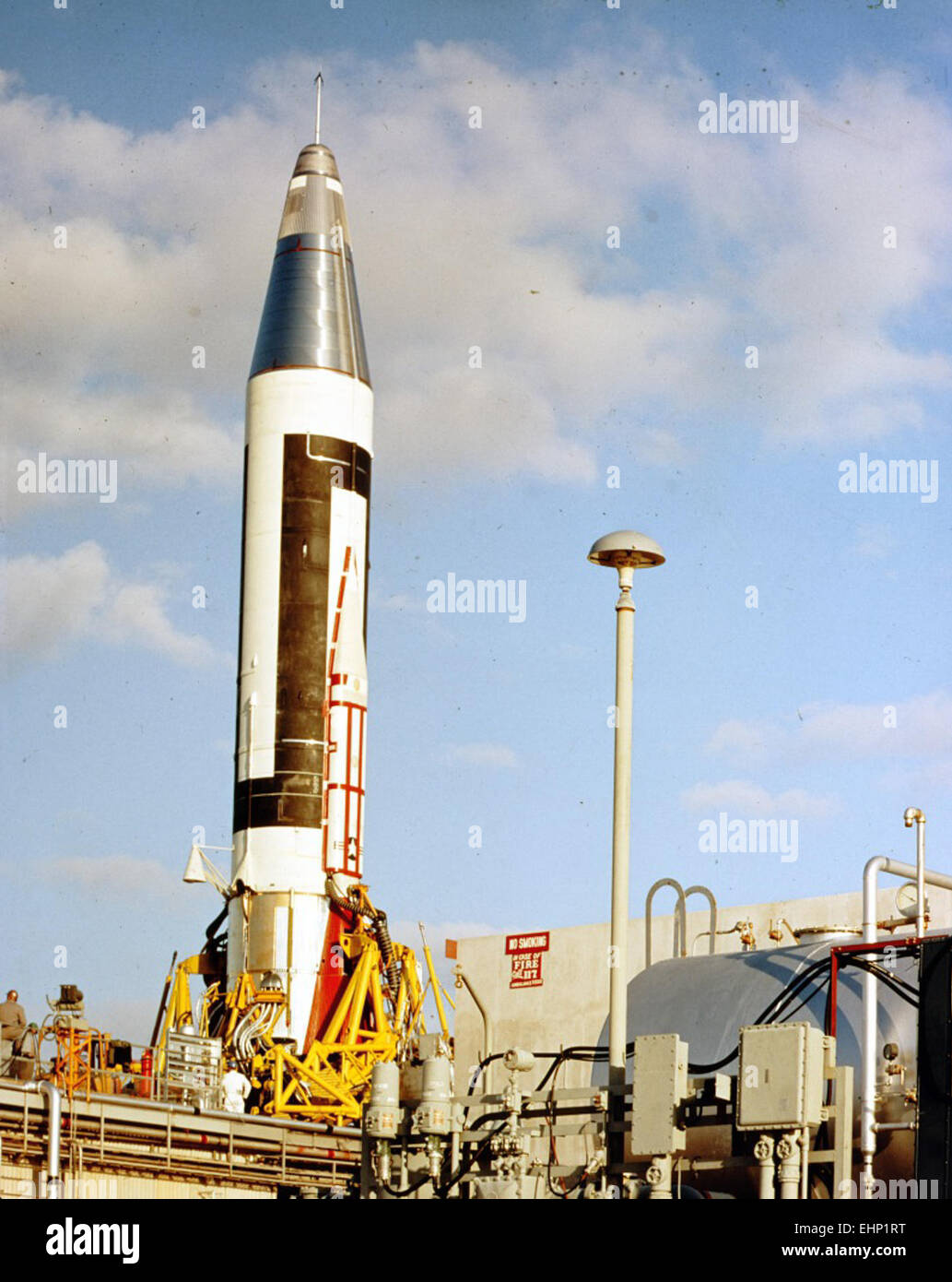 A photograph showing the Atlas 12A rocket on the launch pad, with the ...