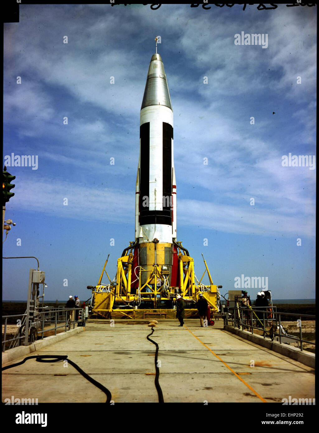 A photograph showing the Atlas missile on its launch pad with the tower ...