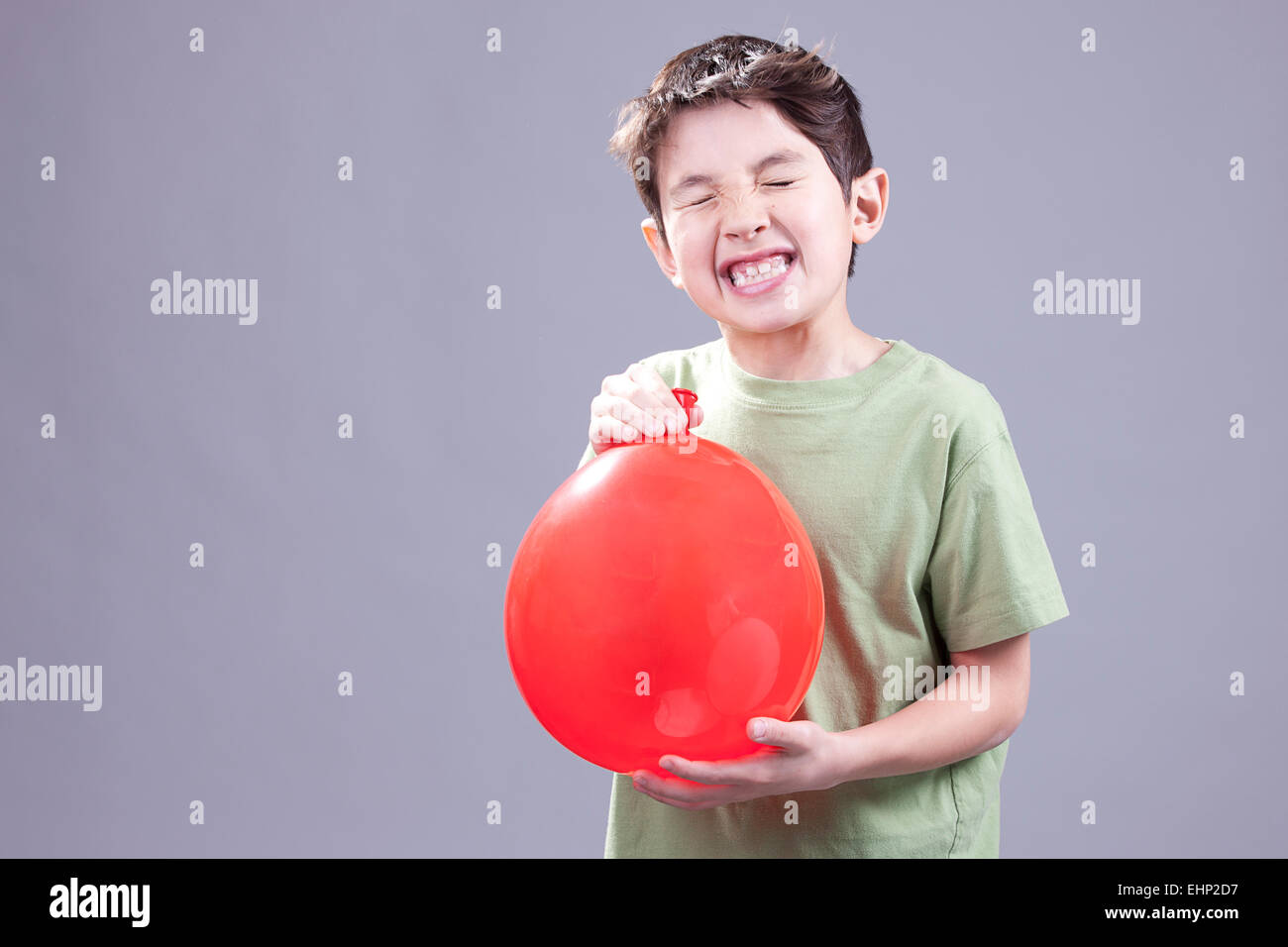 Boy gets air blast from balloon Stock Photo - Alamy