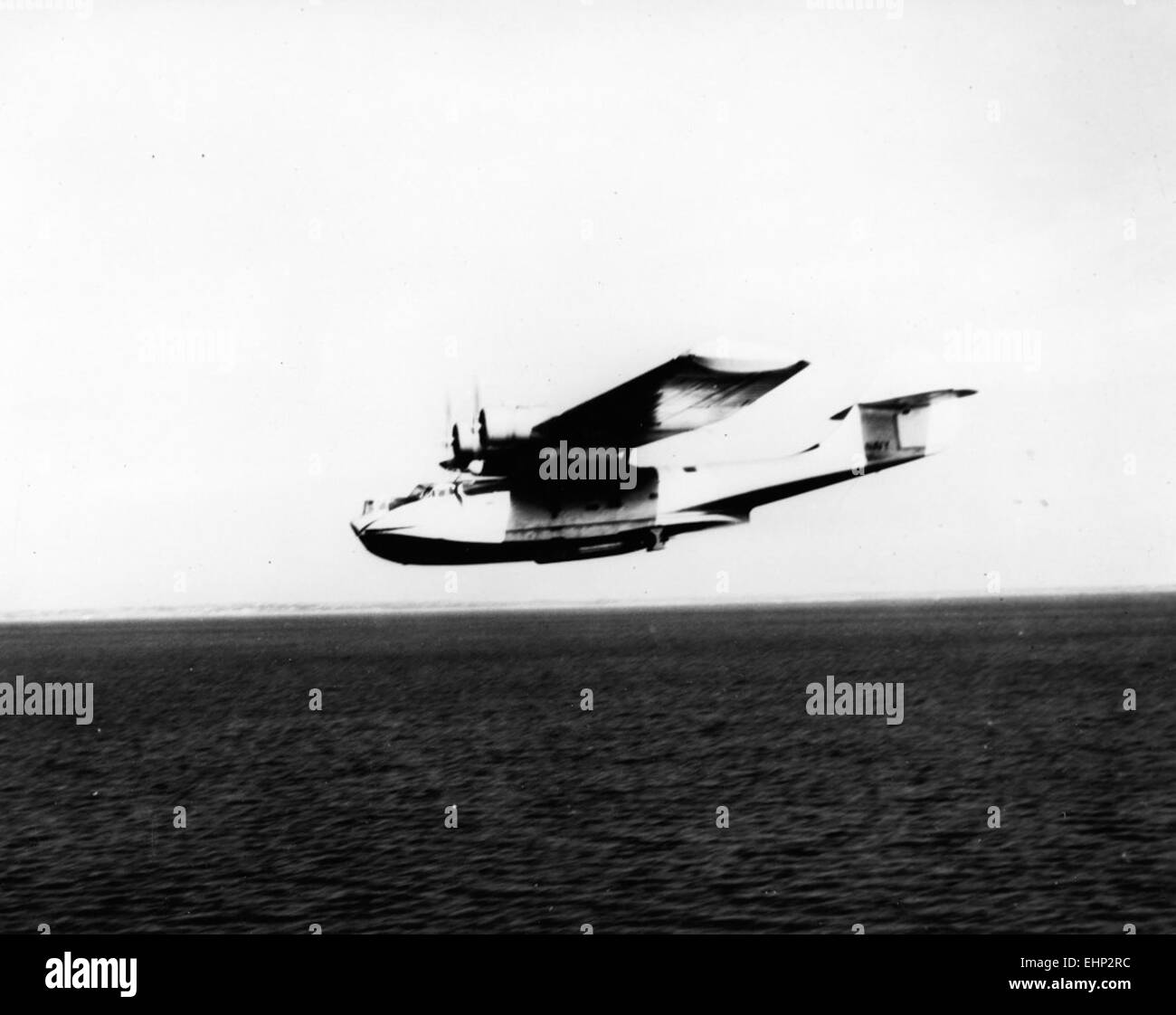 A photograph showing the launch of a torpedo from a Consolidated PBY-3 ...