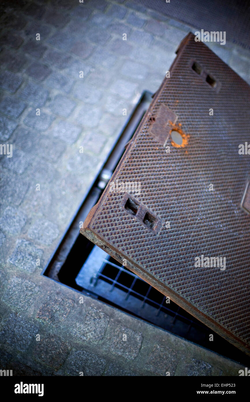 Sewer open in a cobbled street in the city Stock Photo - Alamy