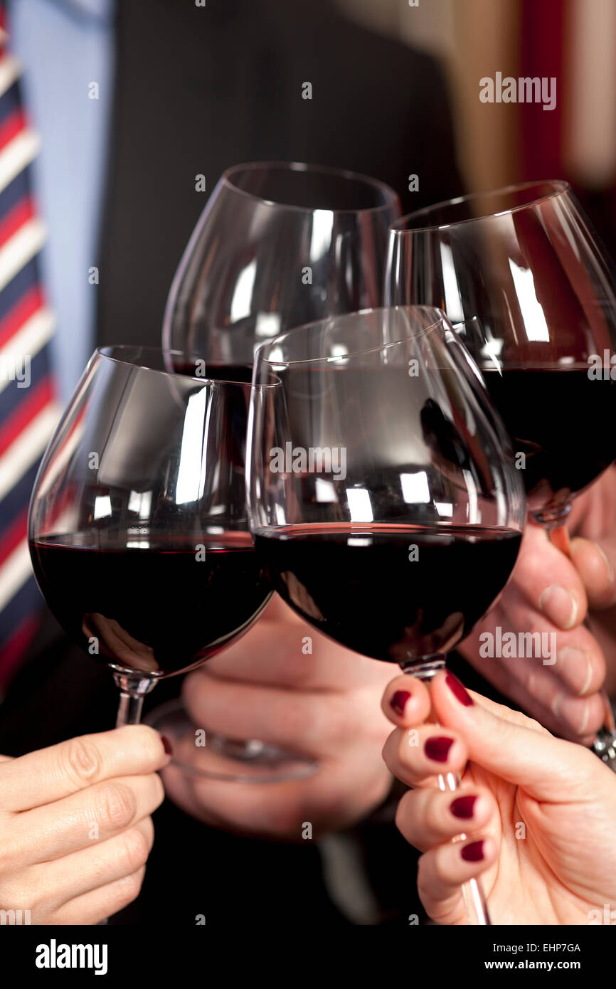 Celebrating and toasting with glasses of red wine Stock Photo - Alamy