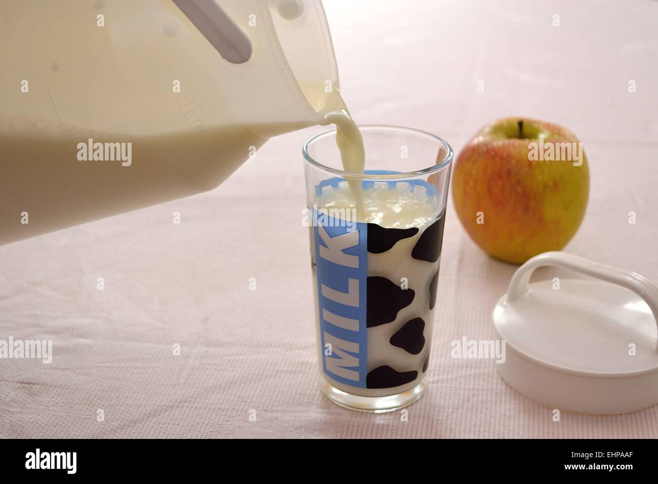 Fresh milk is poured into glass Stock Photo - Alamy