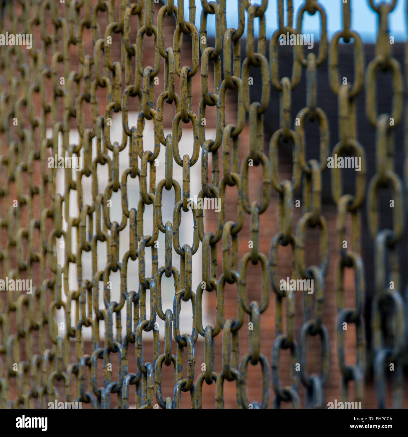 Window obscured by a screen of chains Stock Photo - Alamy