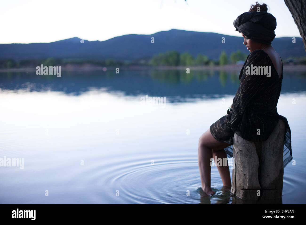 Beautiful woman wading in water Stock Photo - Alamy