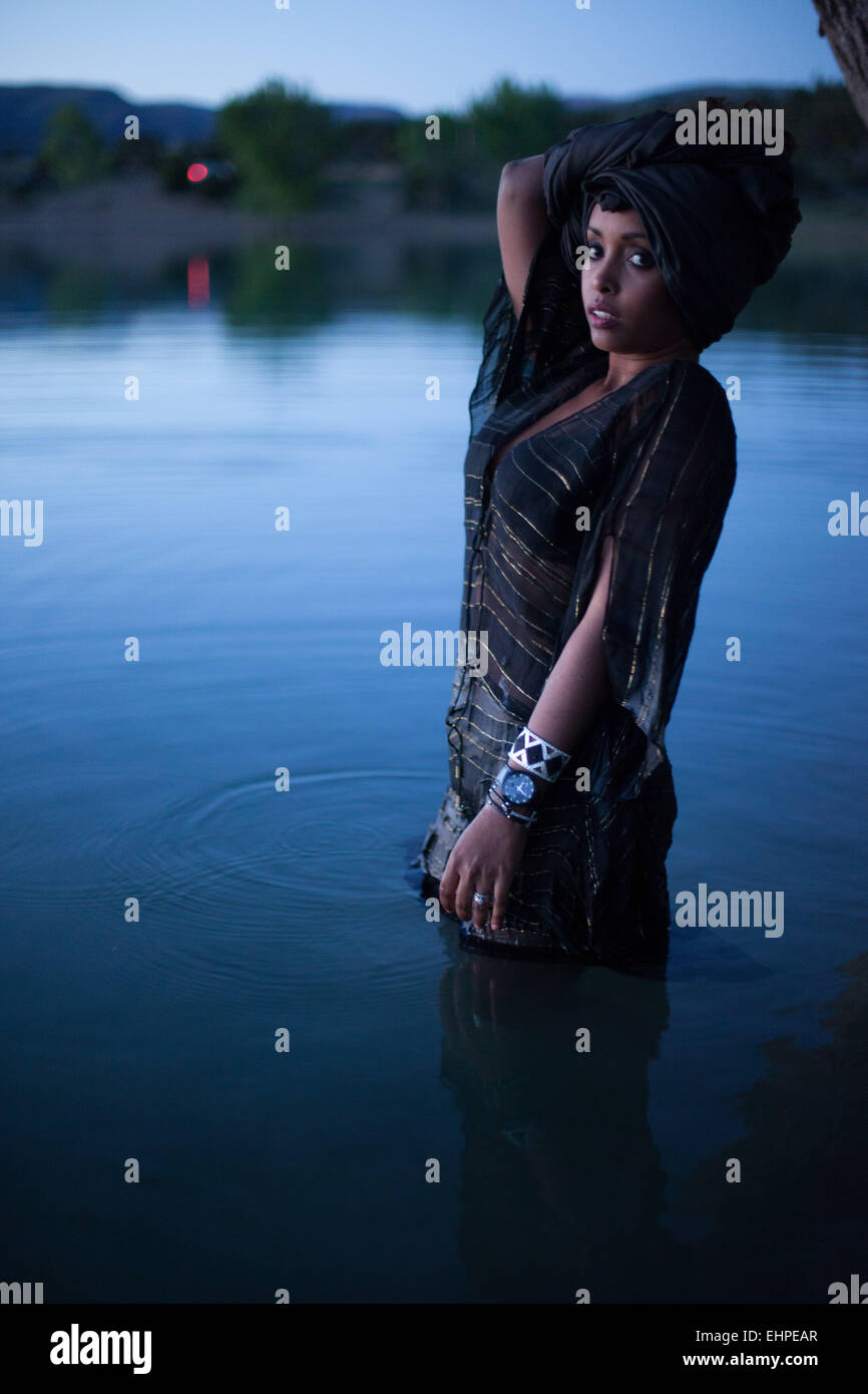 Beautiful woman wading in water Stock Photo - Alamy