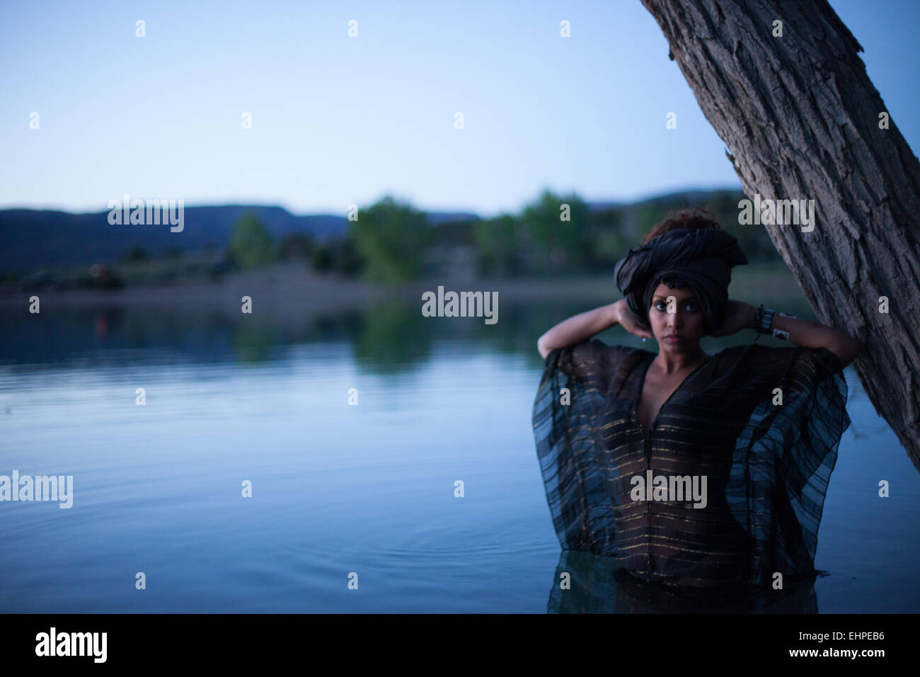 Beautiful woman wading in water Stock Photo - Alamy