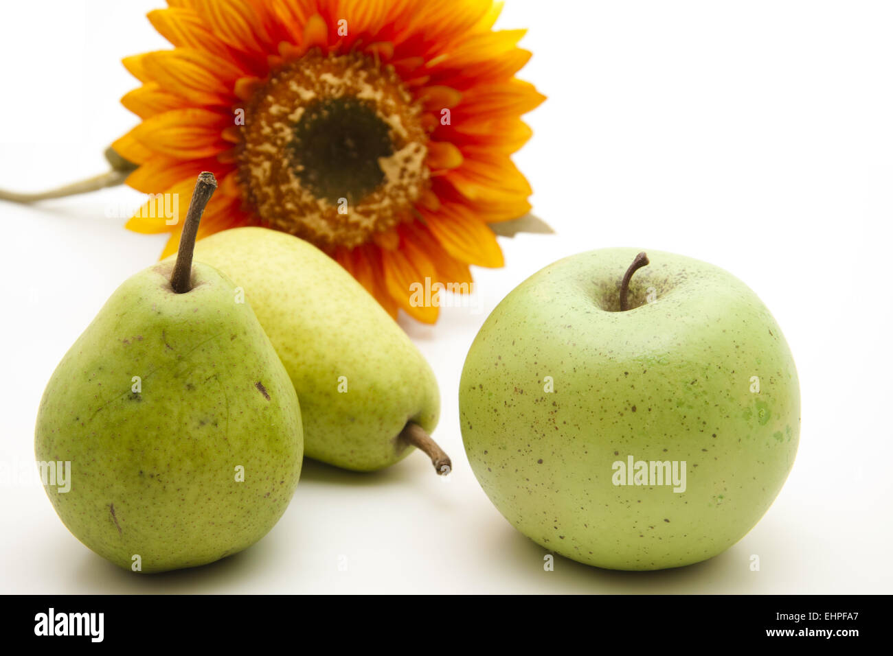 Green pear and apple with sunflower Stock Photo - Alamy