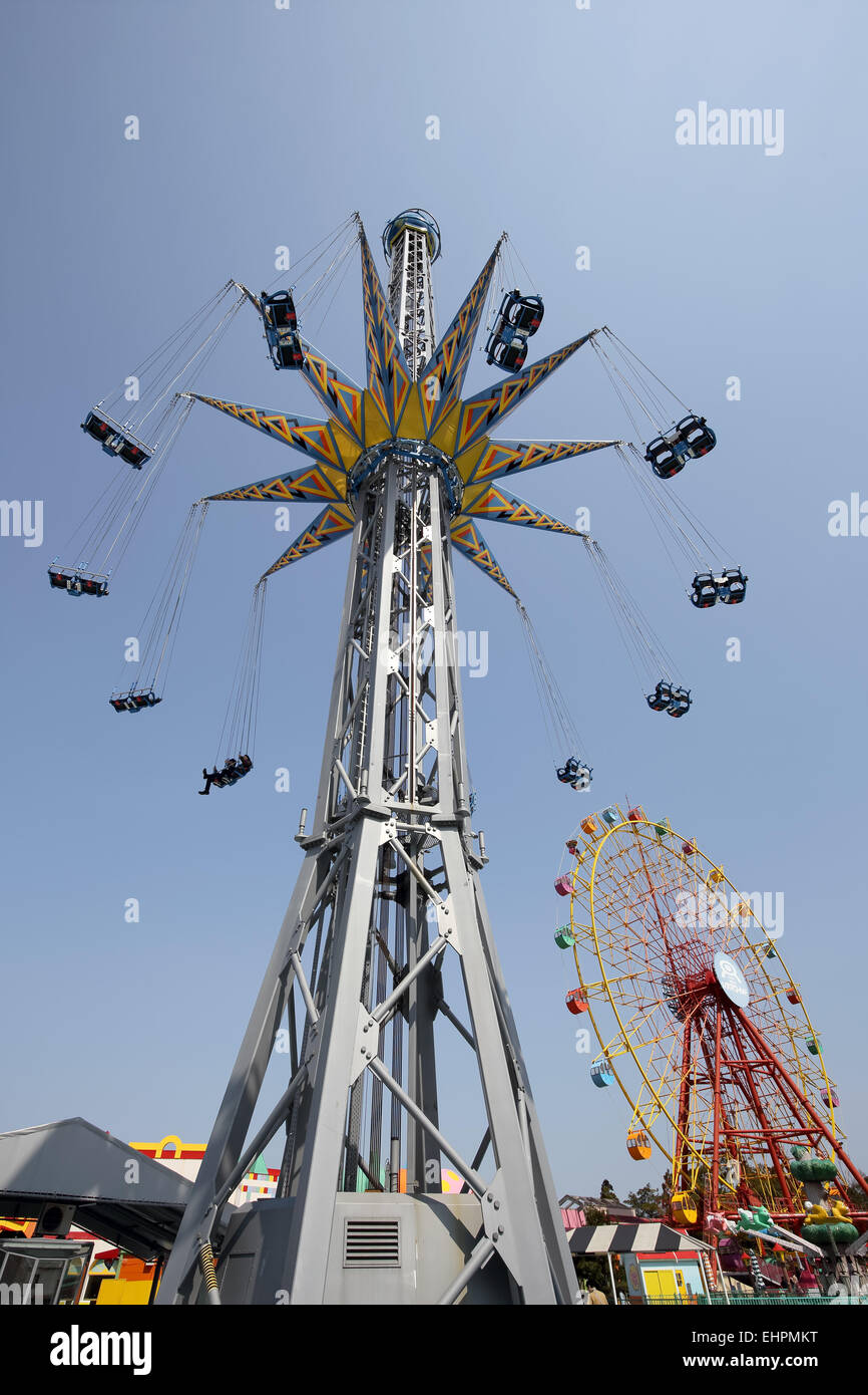 spinning star flyer ride in amusement park Stock Photo - Alamy