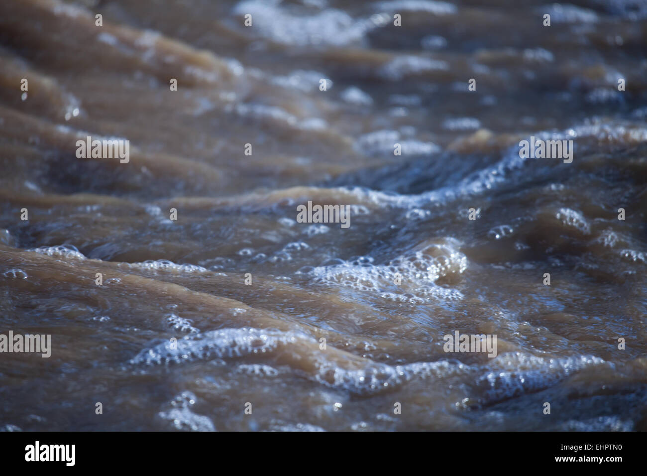 rapid stream of muddy river Stock Photo - Alamy