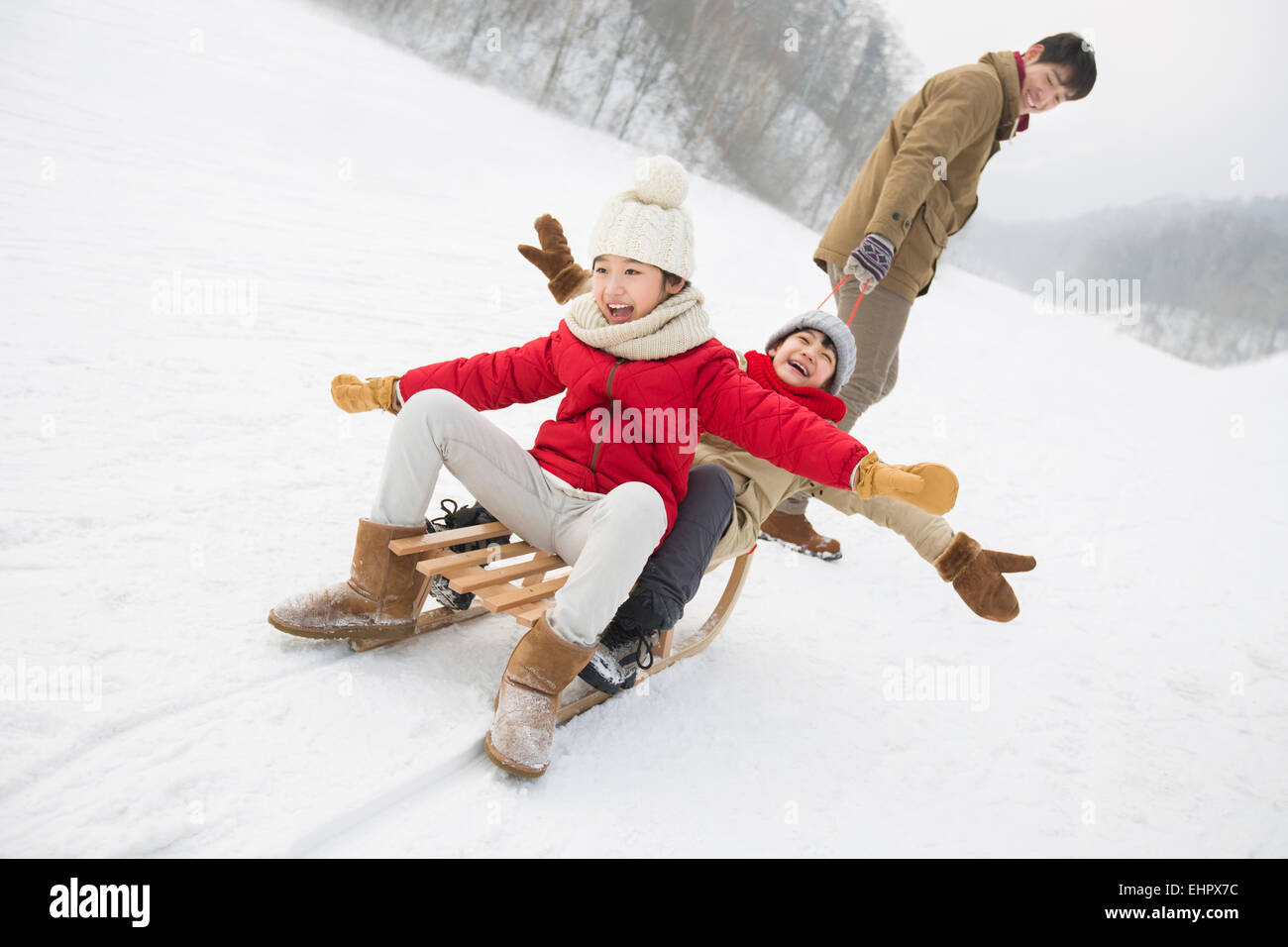 Boys pulling sled hi-res stock photography and images - Alamy