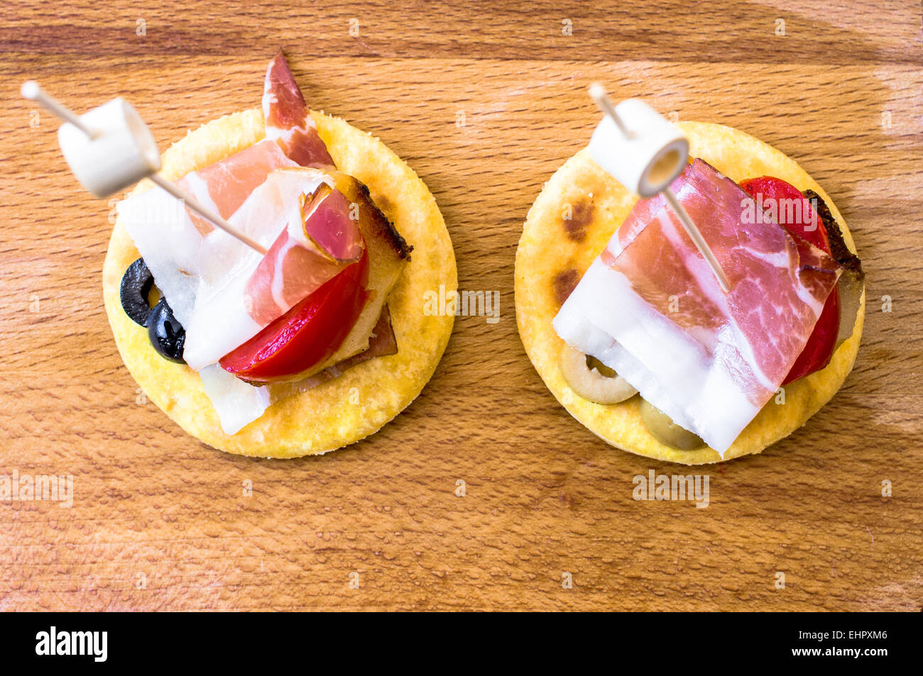 Tapas with bacon and potatoes, olives and tomatoes Stock Photo - Alamy