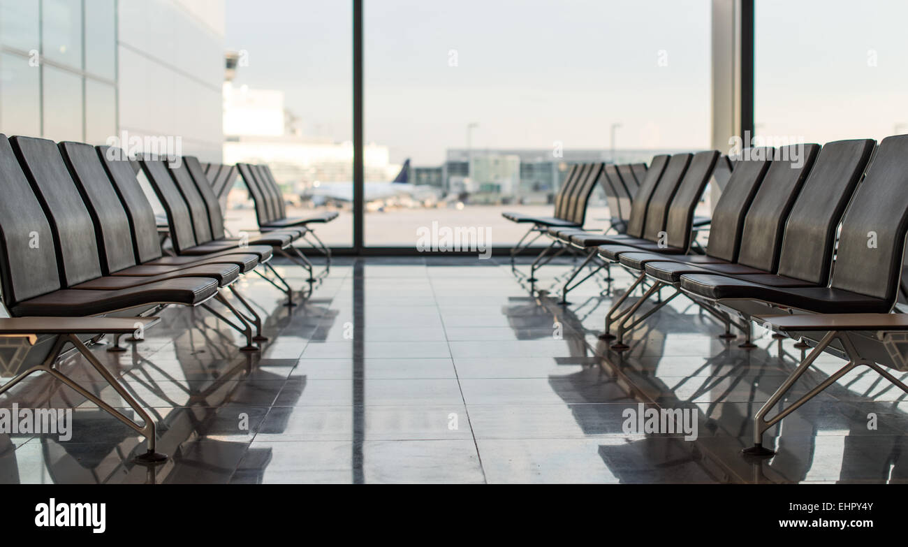 Empty seats in terminal waiting room in airport Stock Photo - Alamy