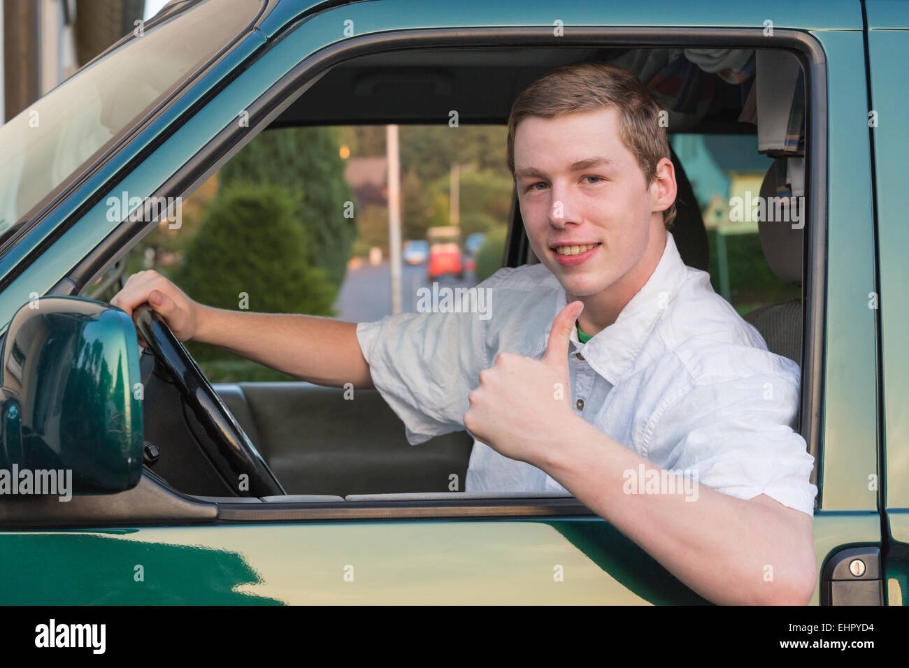 young man in a car smiling Stock Photo - Alamy