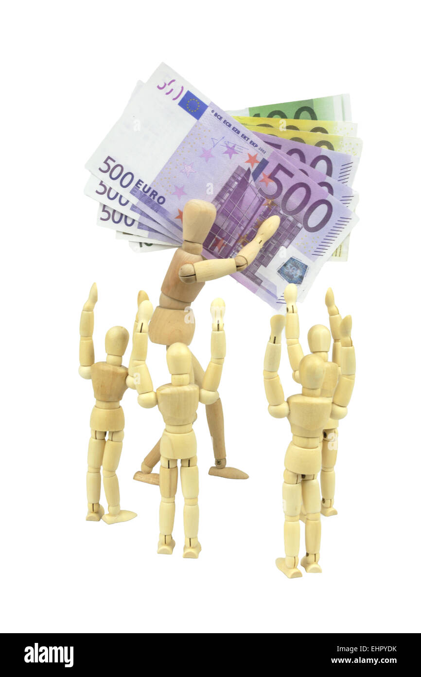 Wooden figures symbolise the adoration of money 5 Stock Photo - Alamy