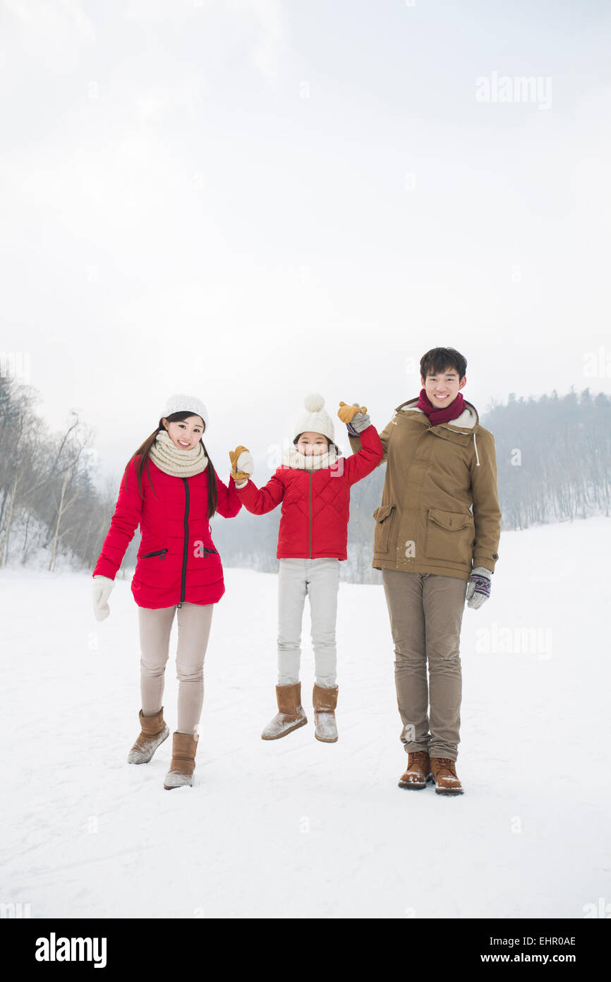 Happy family playing on the snow Stock Photo - Alamy