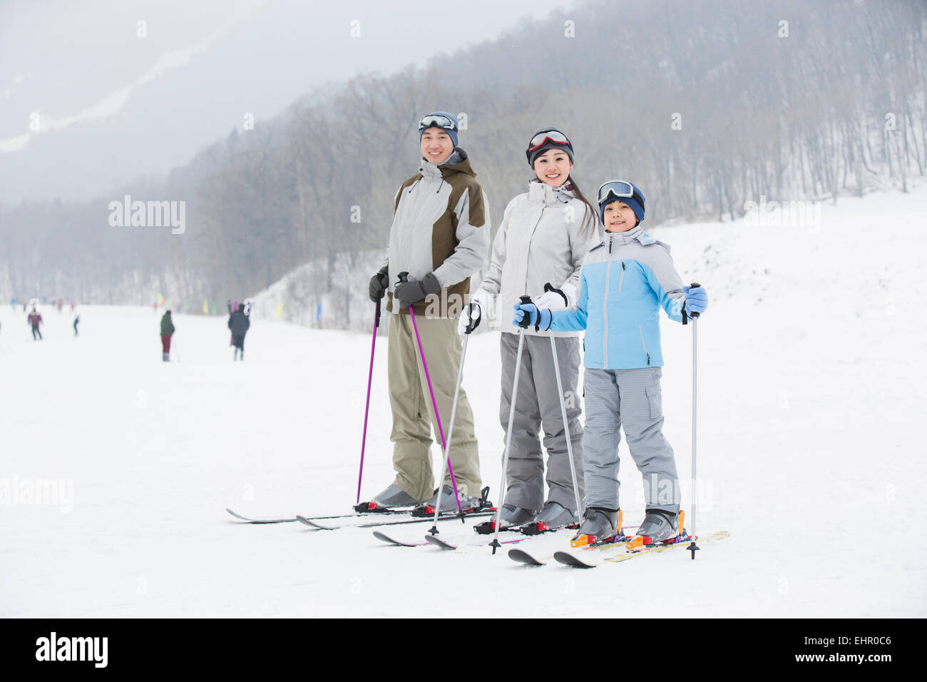 Young family skiing in ski resort Stock Photo - Alamy