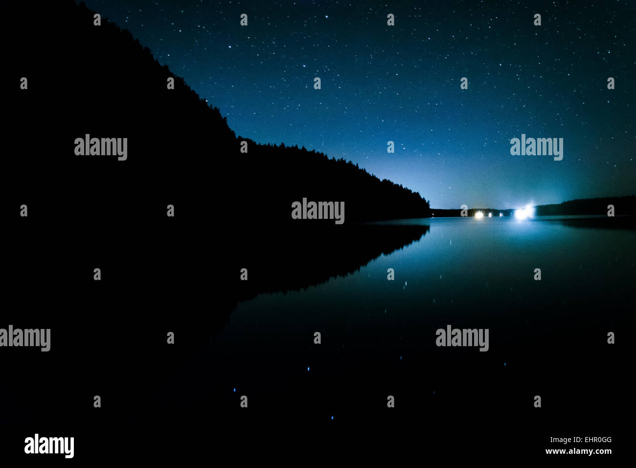Stars in the night sky reflecting in Echo Lake, at Acadia National Park ...