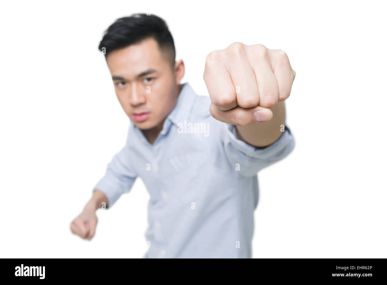 Young man punching towards the camera Stock Photo - Alamy