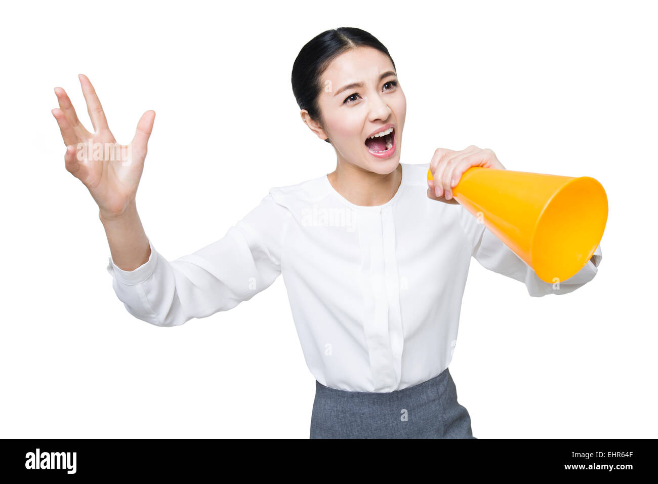 Young woman shouting into megaphone Stock Photo - Alamy