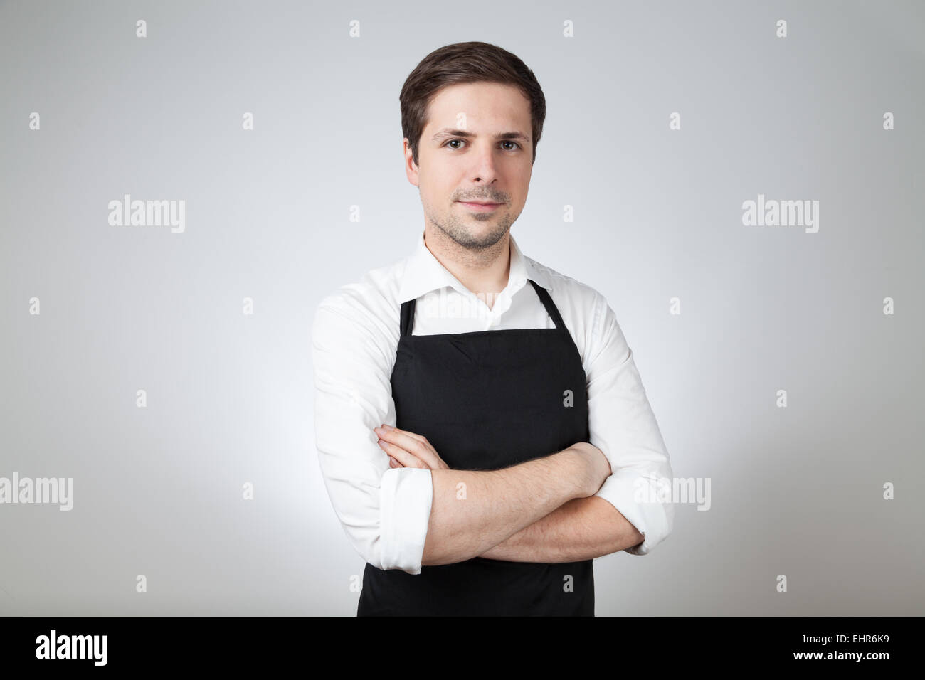 shop assistant with apron on grey background (supermarket; coffee bar ...