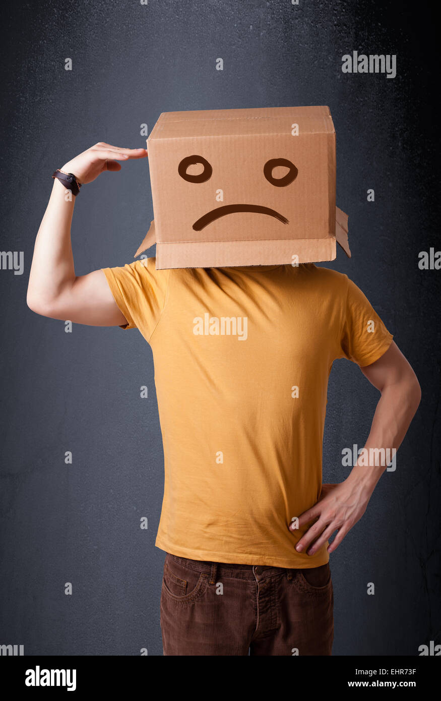 Young man with a brown cardboard box on his head with sad face Stock ...