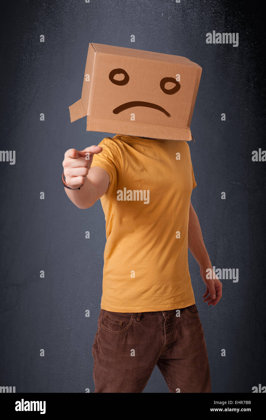 Young man with a brown cardboard box on his head with sad face Stock ...