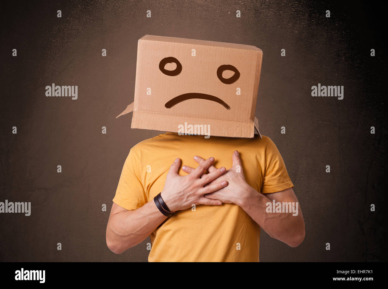 Young man with a brown cardboard box on his head with sad face Stock ...