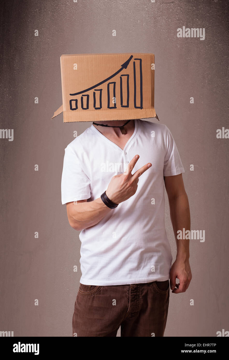 Young man gesturing with a cardboard box on his head with diagram Stock ...