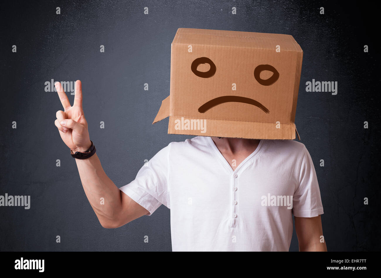 Young man with a brown cardboard box on his head with sad face Stock ...