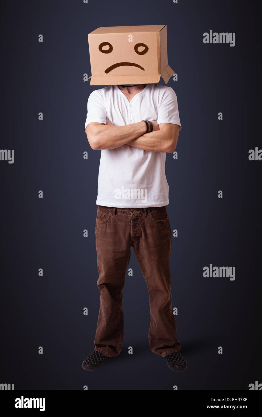 Young man with a brown cardboard box on his head with sad face Stock ...